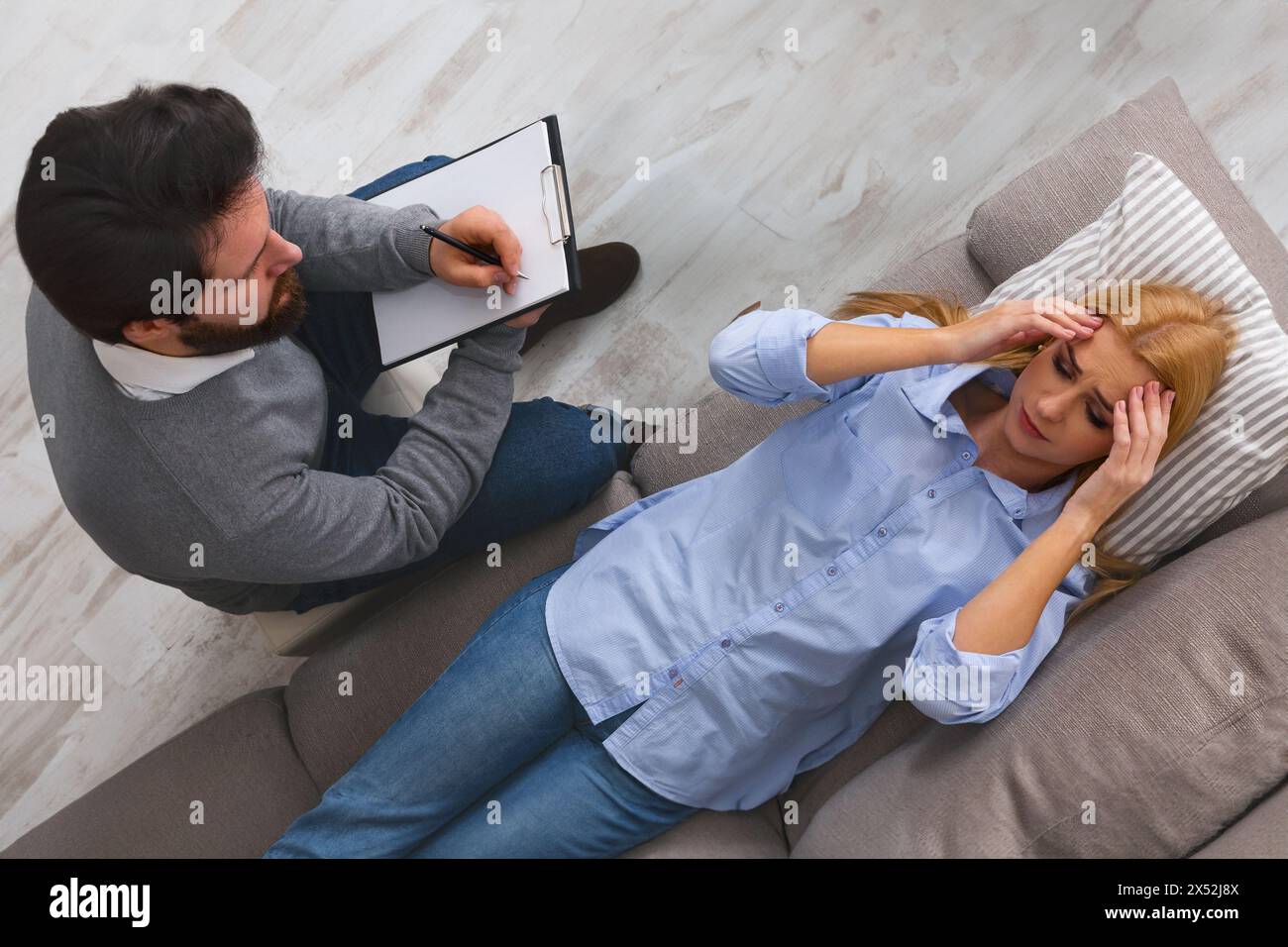 Psychologist listening to desperate patient and writing down notes ...