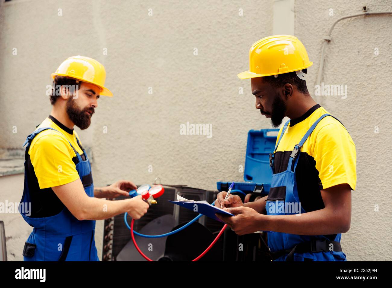 Trained engineer using set of manometers to read pressure of liquids ...