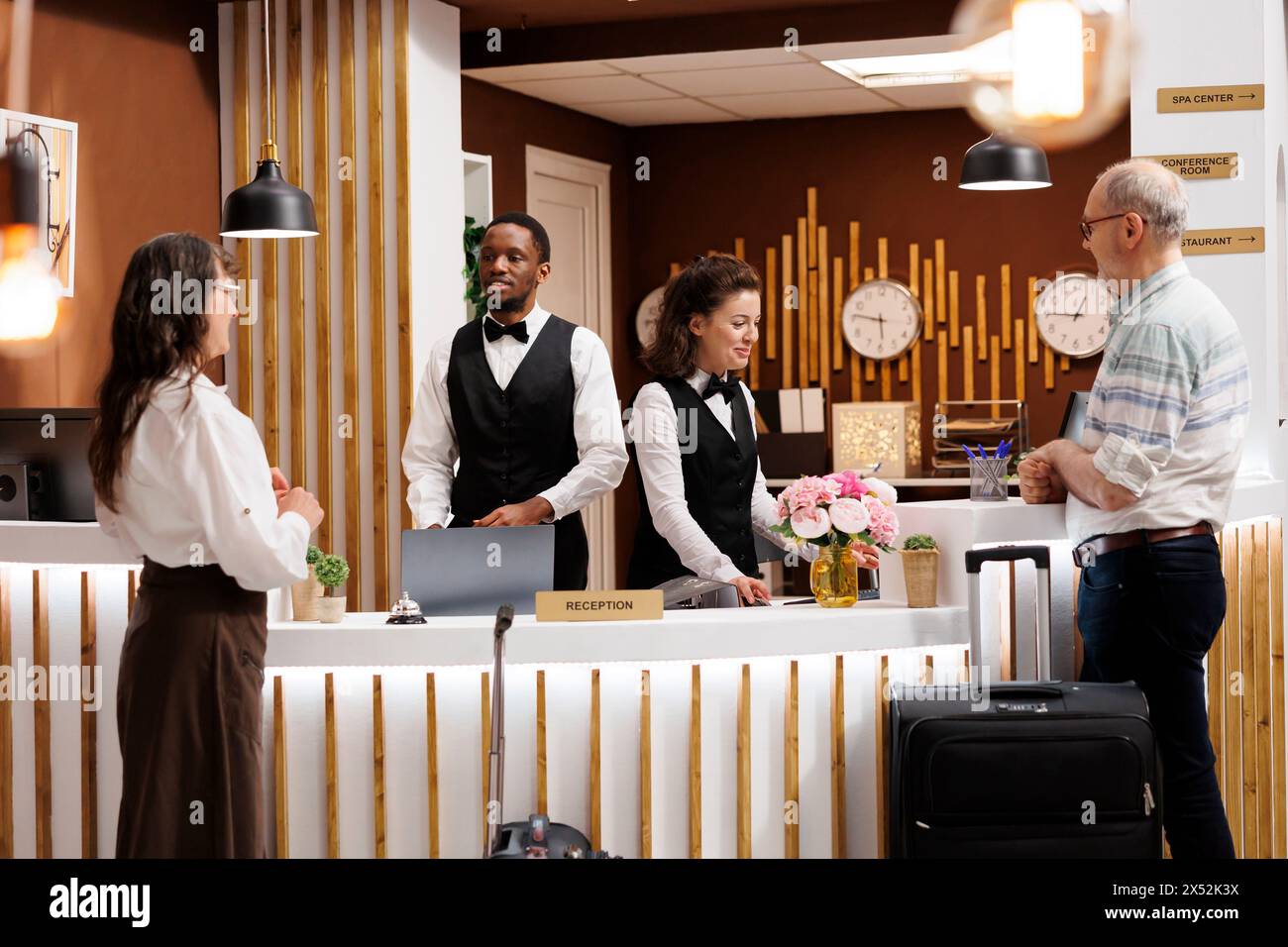 Welcoming visitors elderly couple holding hi-res stock photography and ...