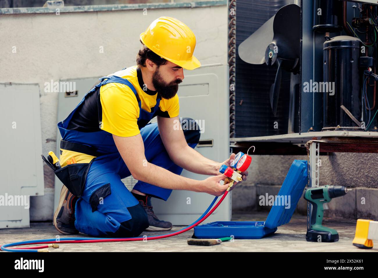 Certified repairman doing annual hvac system maintenance, assembling ...