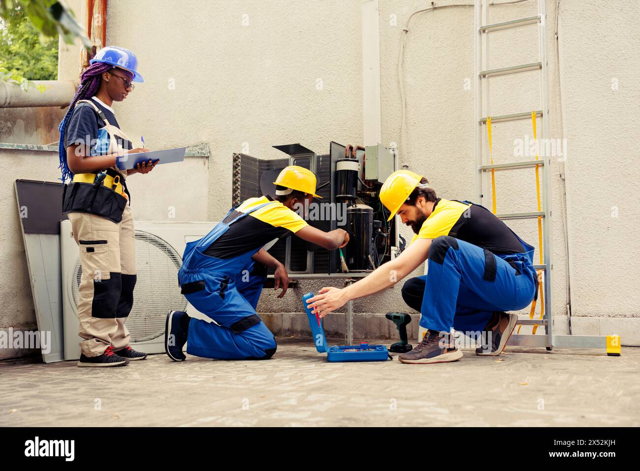 Diverse crew contracted by home owner to fix broken air conditioner ...