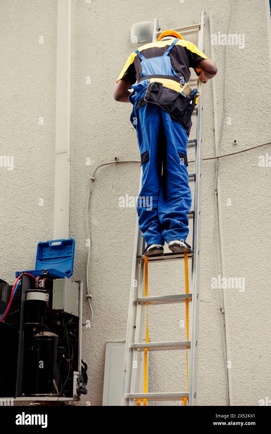 Competent mechanic in professional uniform with technical equipment ...