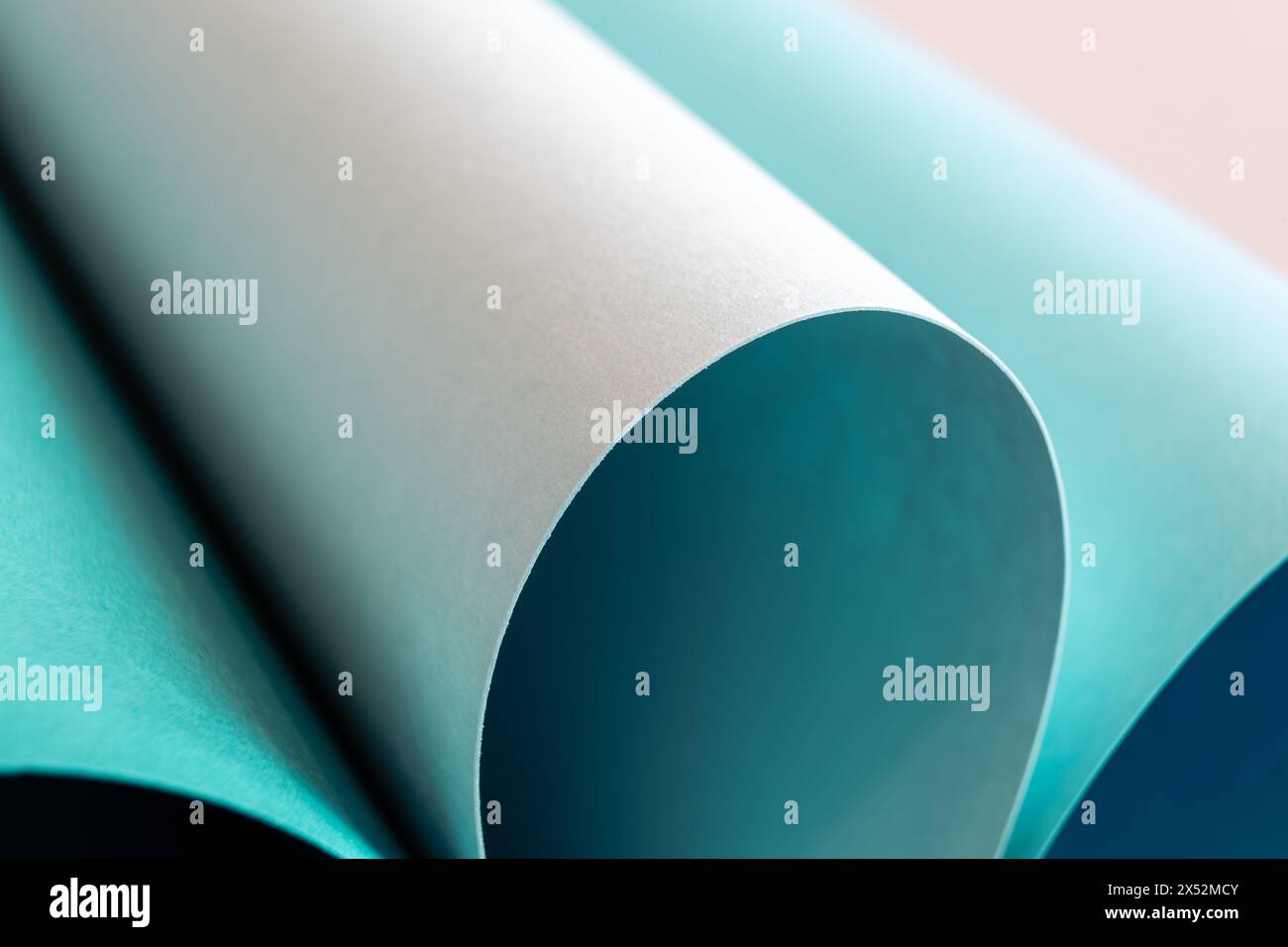 Curved cylinders of teal and white paper Stock Photo - Alamy