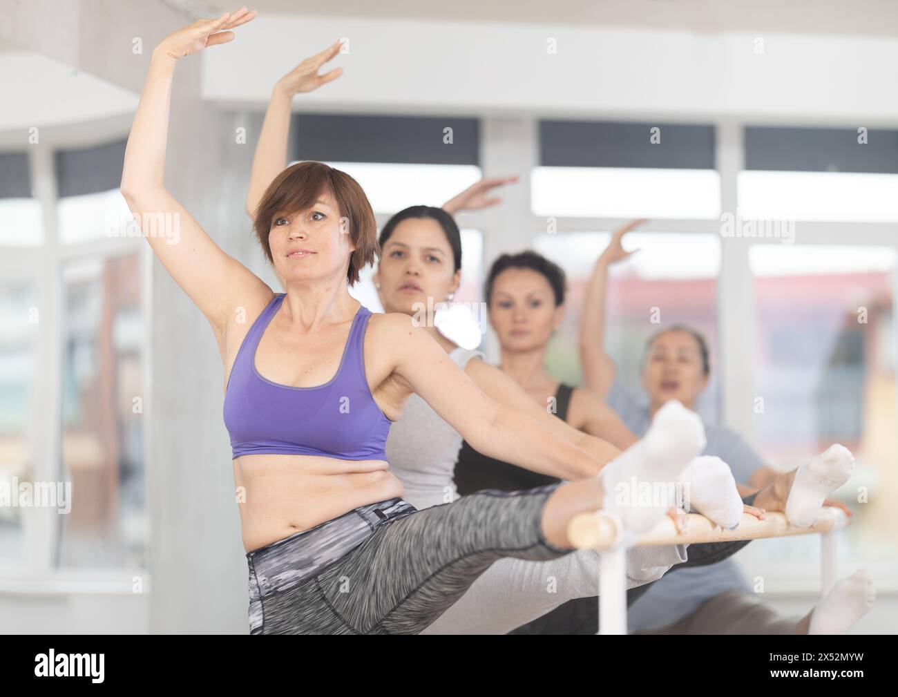 Ballet pose grand batman - women of different ages at choreography ...