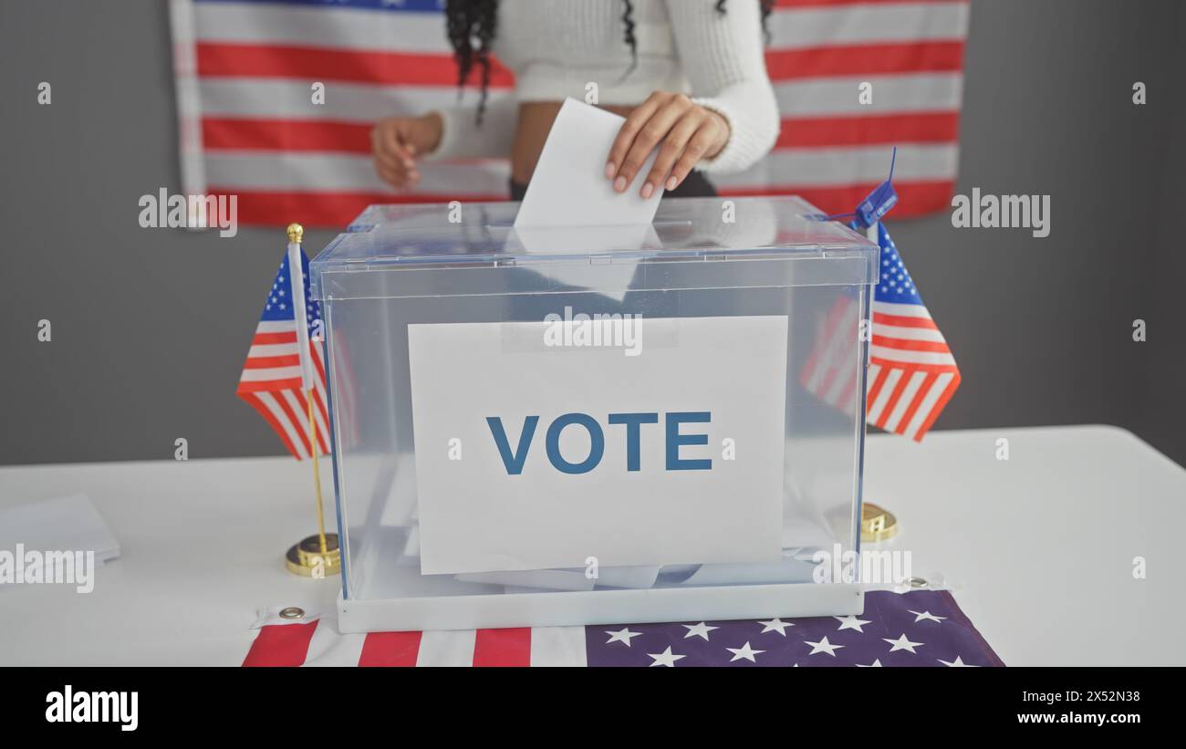 Woman casting ballot at a united states electoral station with american ...