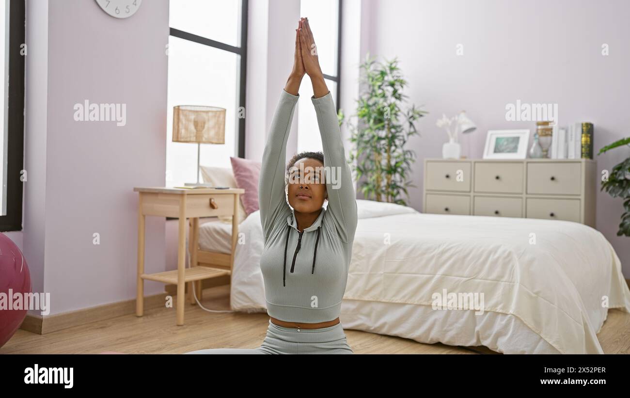 African american woman practicing yoga in a modern bedroom setup Stock ...