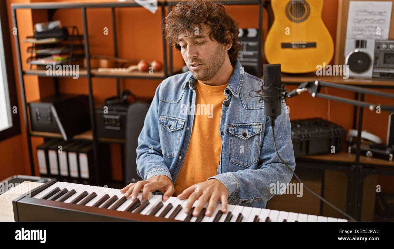 Hispanic man playing keyboard in a modern music studio Stock Photo - Alamy