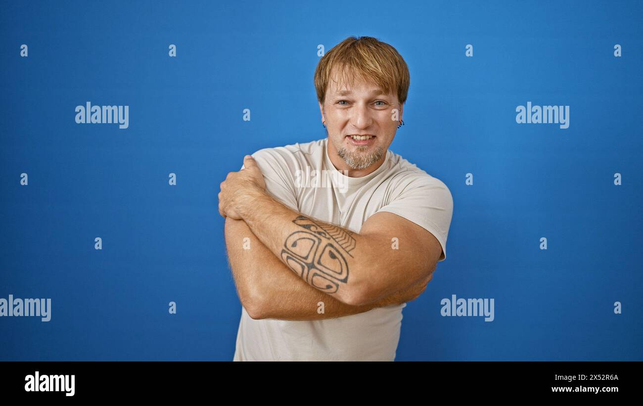 Portrait of a confident young caucasian man with beard, blond hair, and ...