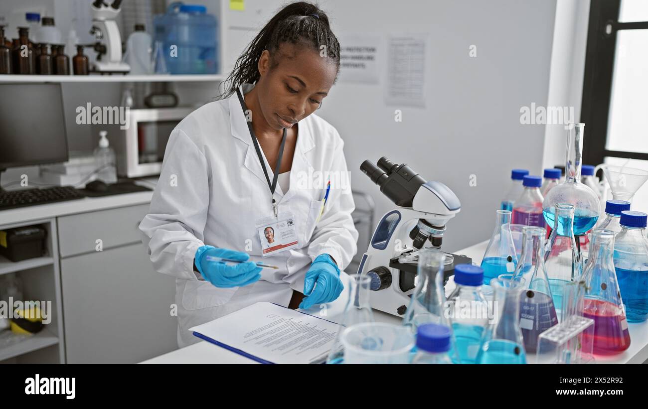 African american female scientist analyzing samples in a laboratory ...
