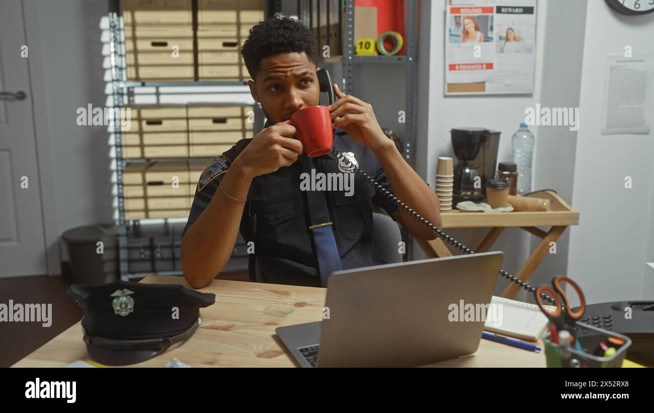 African american police officer sipping coffee while on a phone call in ...
