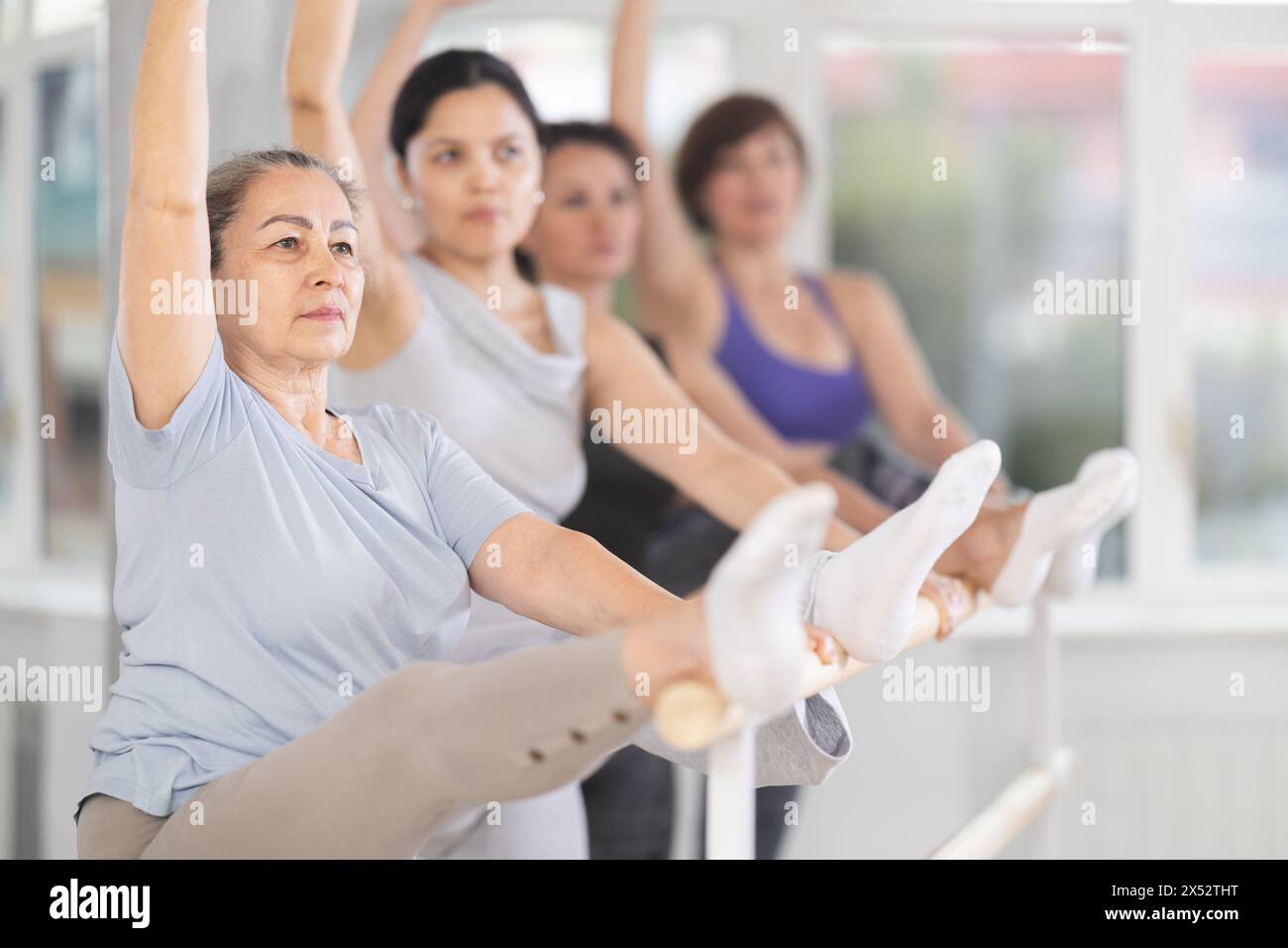 Ballet pose grand batman - women of different ages at choreography ...