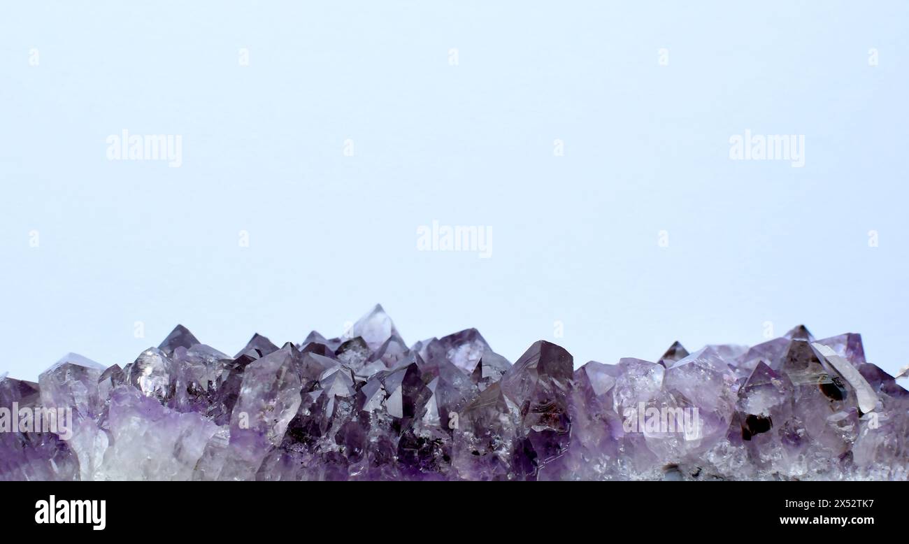 Beautiful druse of natural purple mineral amethyst on a white ...