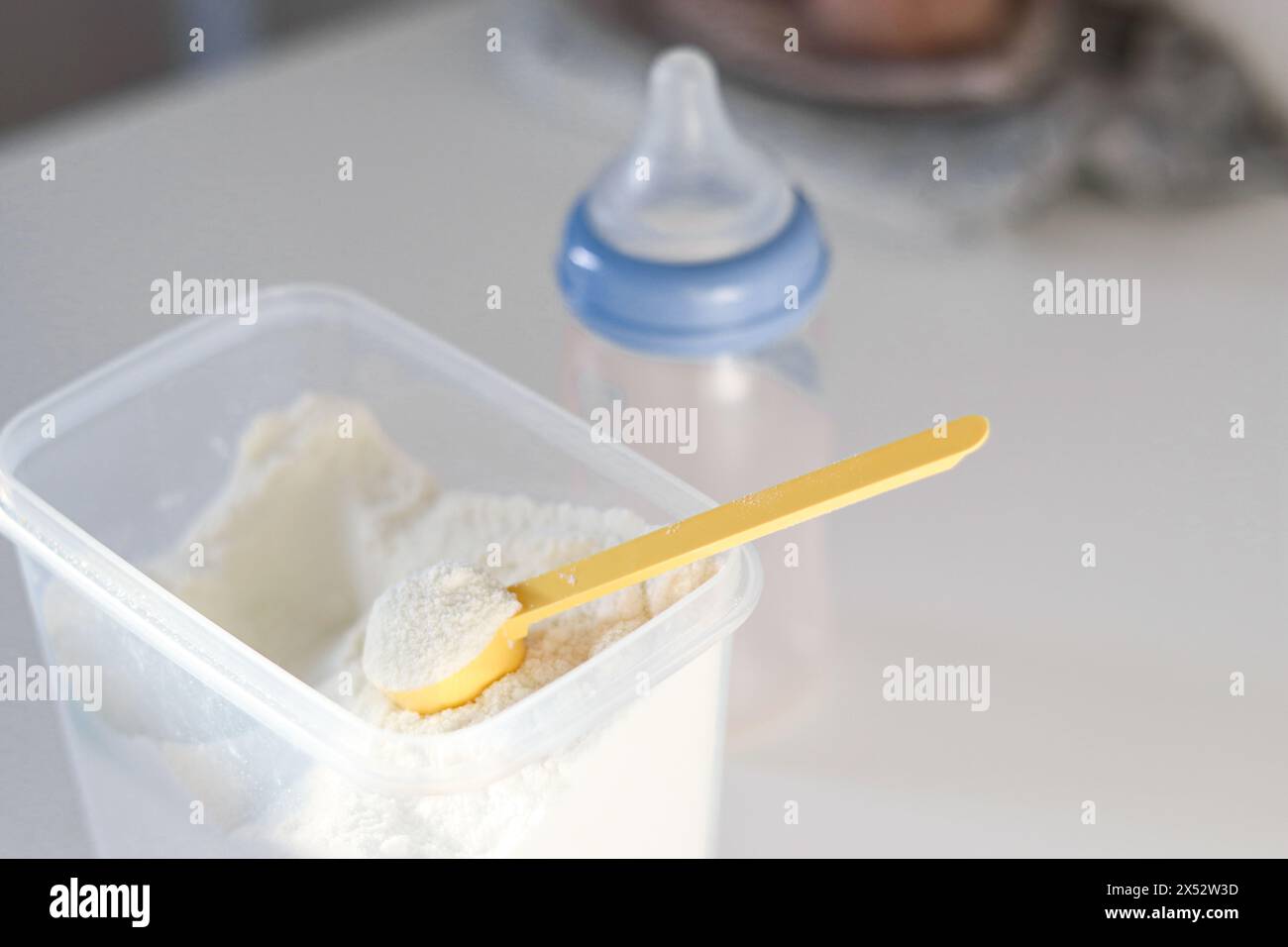 Dry powder formula milk for feeding babies in a can with yellow plastic ...
