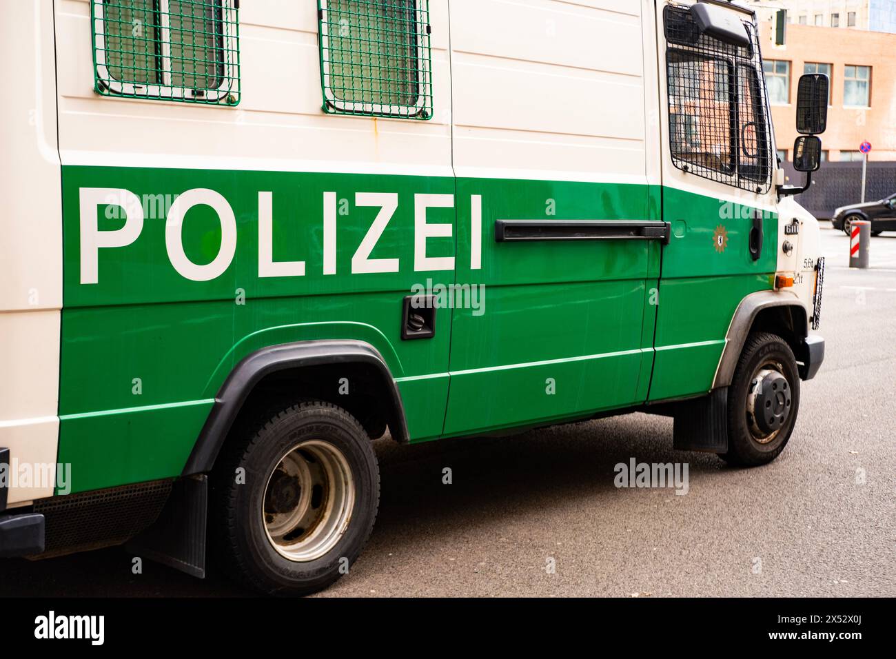 white and green police bus parked on street in Berlin, symbol law and ...