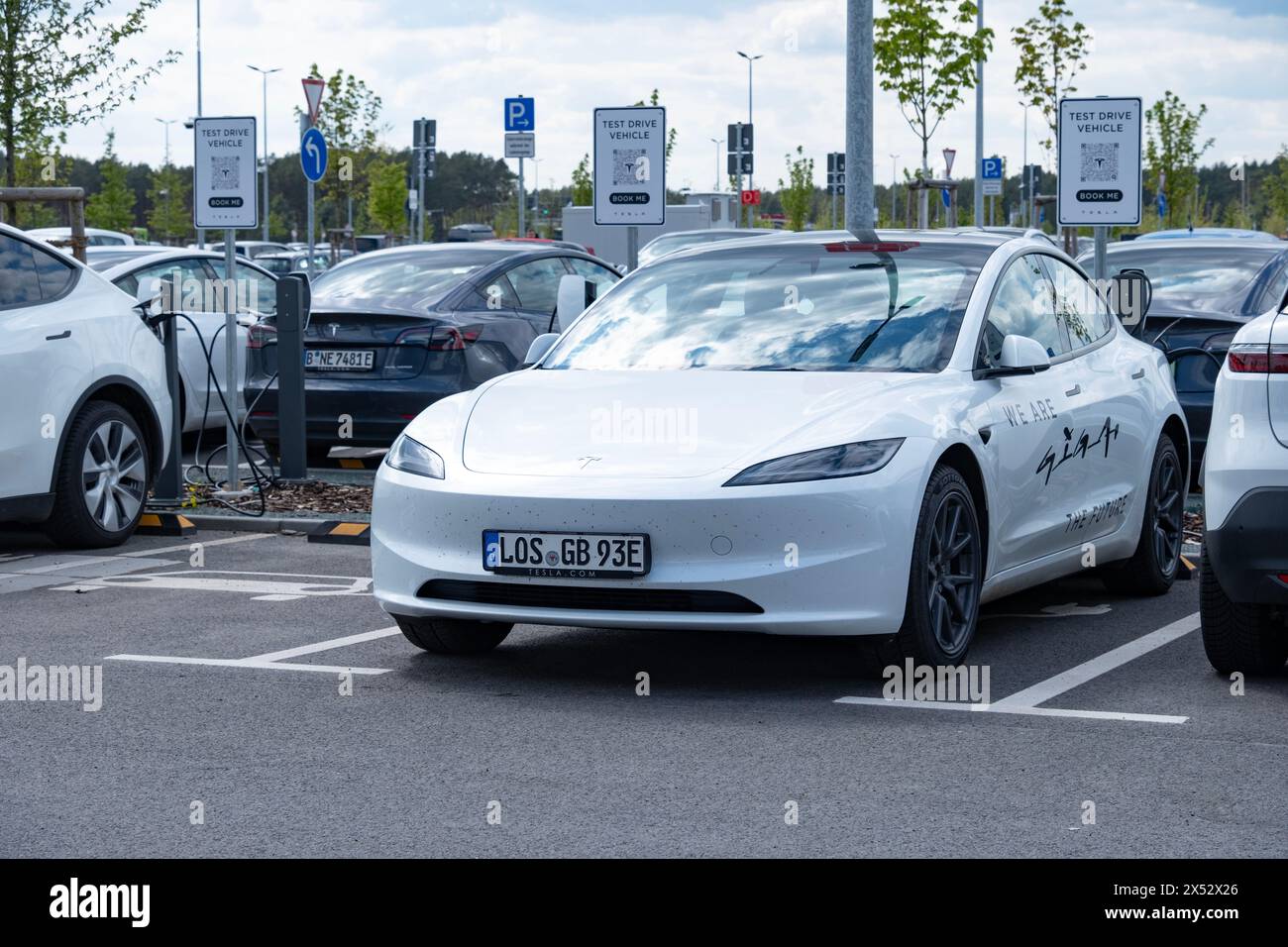 Tesla model y electric car on Free charging station, Tesla-Supercharger ...