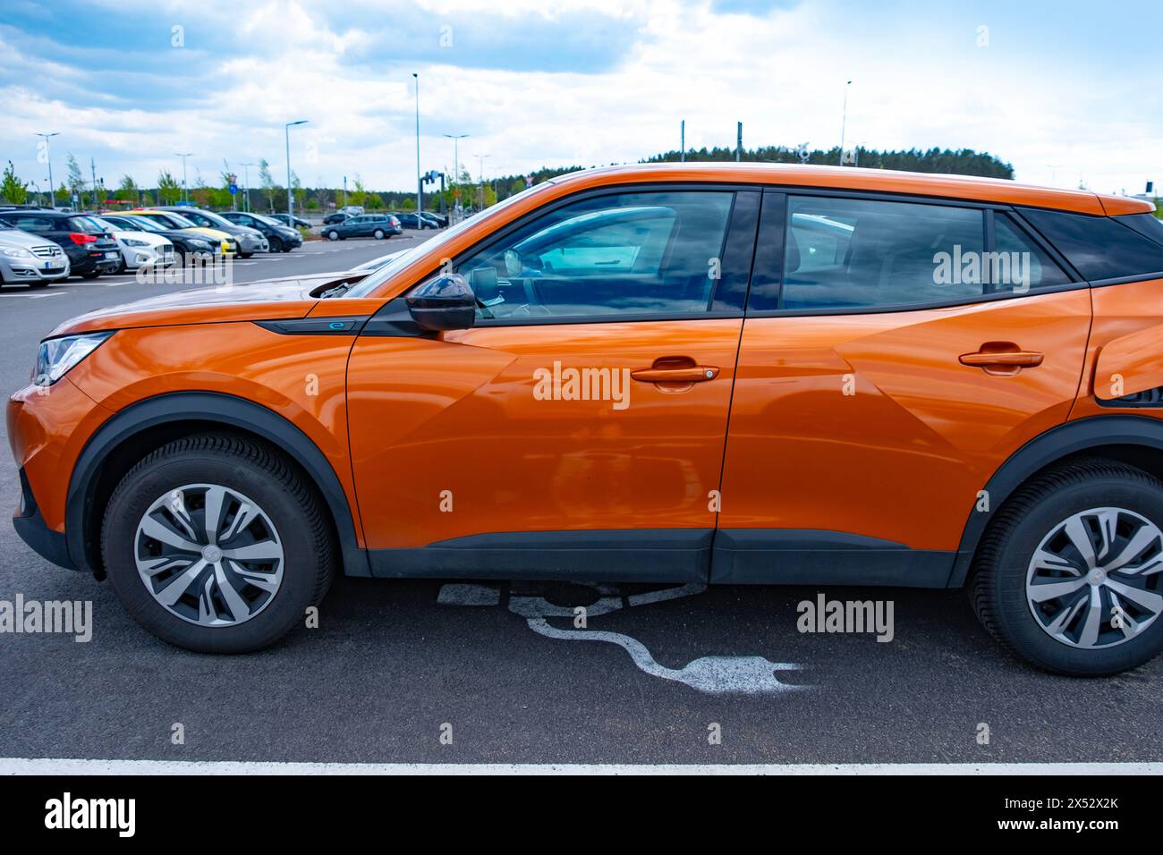electric car Peugeot e-2008 on street charging station, Automotive ...