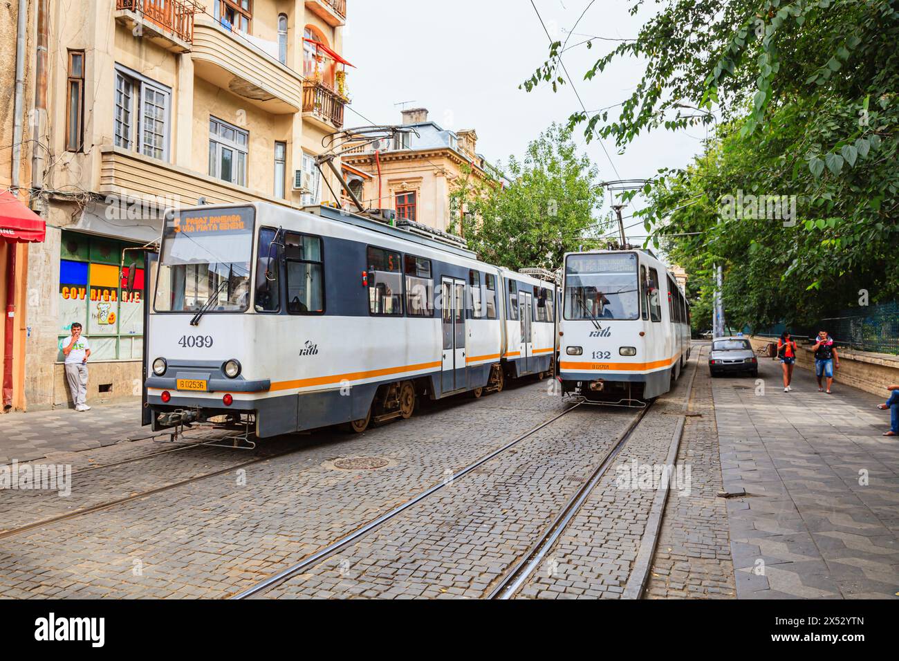 Trams: tramcars and tram rails in cobbled streets of downtown Bucharest ...