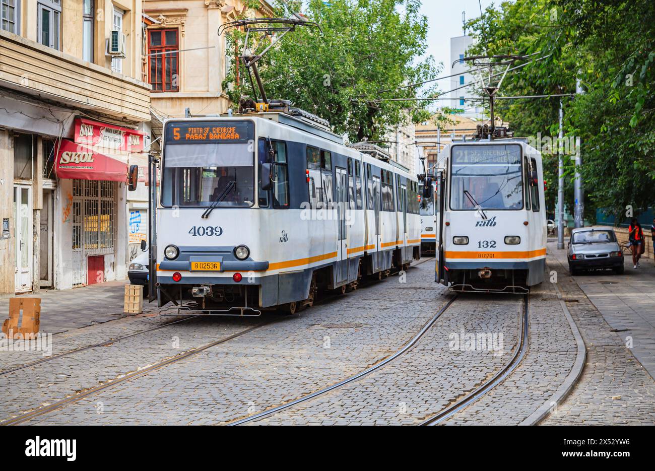 Trams: tramcars and tram rails in cobbled streets of downtown Bucharest ...
