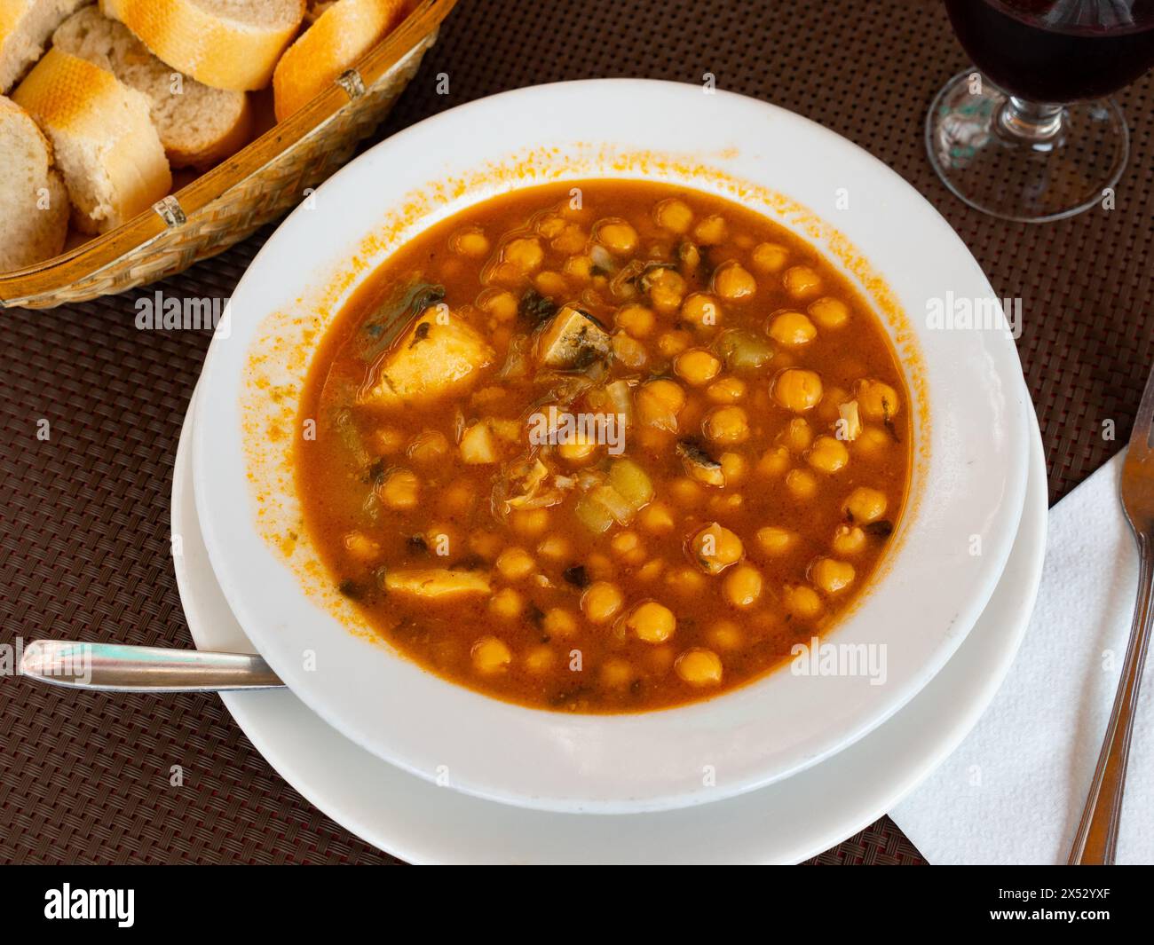 Chickpea stew served with cod fish Stock Photo - Alamy