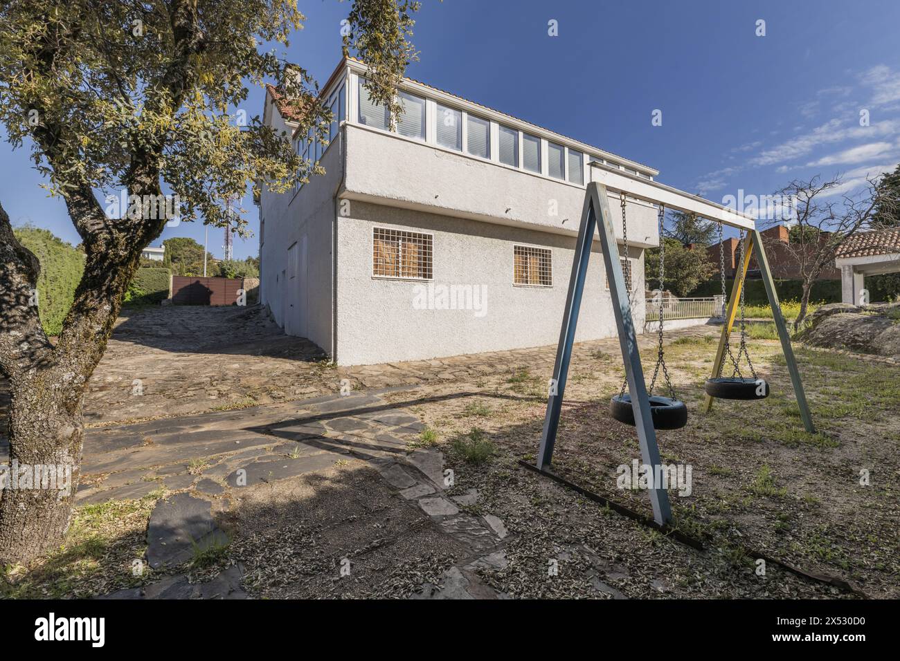 The children sit on the chairs facing each other and alternately push ...