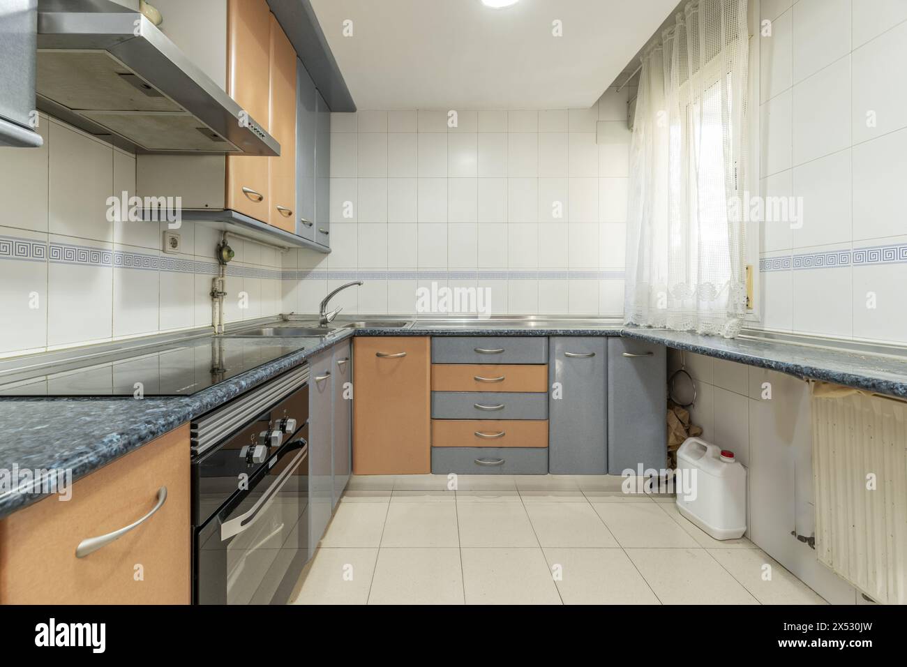 Kitchen with L-shaped base units, blue countertop and combined wood and ...