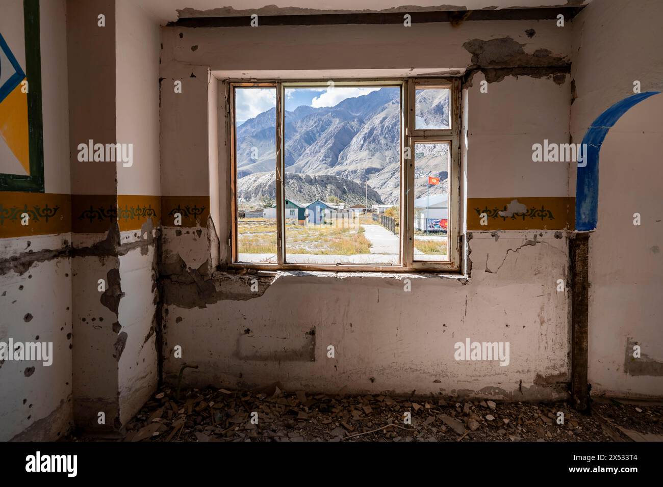View through a window onto the mountain landscape, abandoned destroyed ...