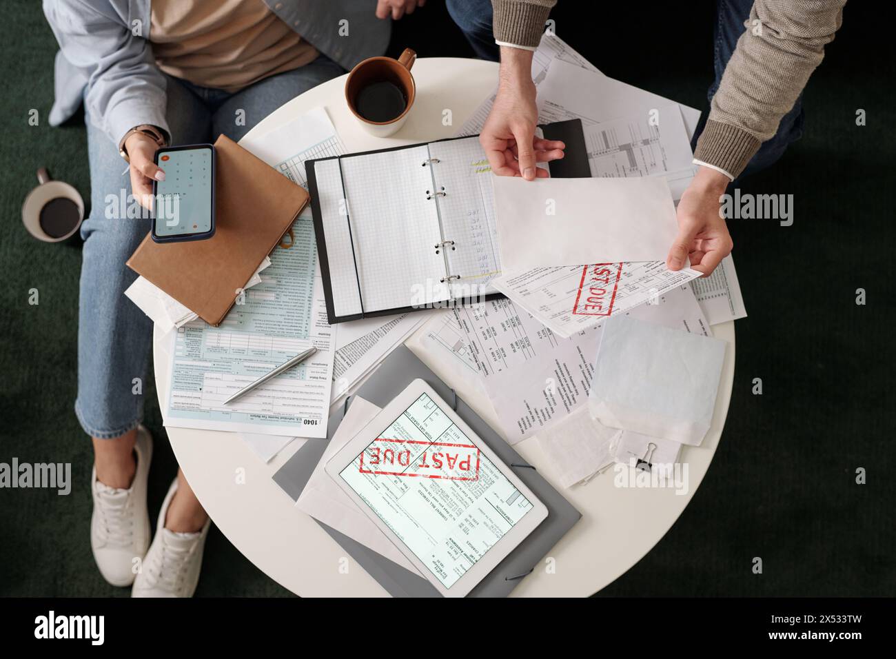 Overview of young unrecognizable man taking bill with past due stamp ...