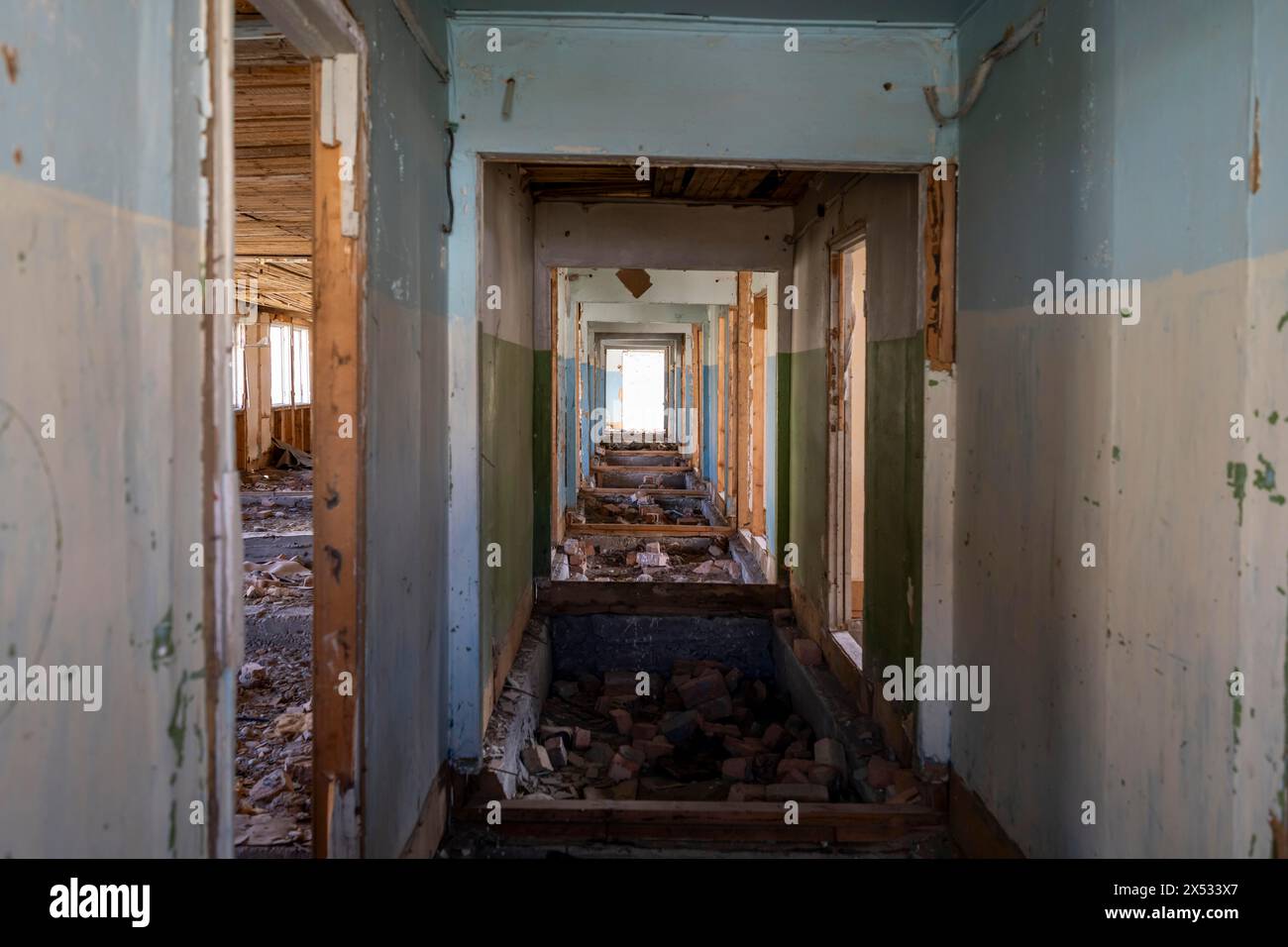 Destroyed abandoned corridor of the old Soviet school, ghost town, Engilchek, Tian Shan ...