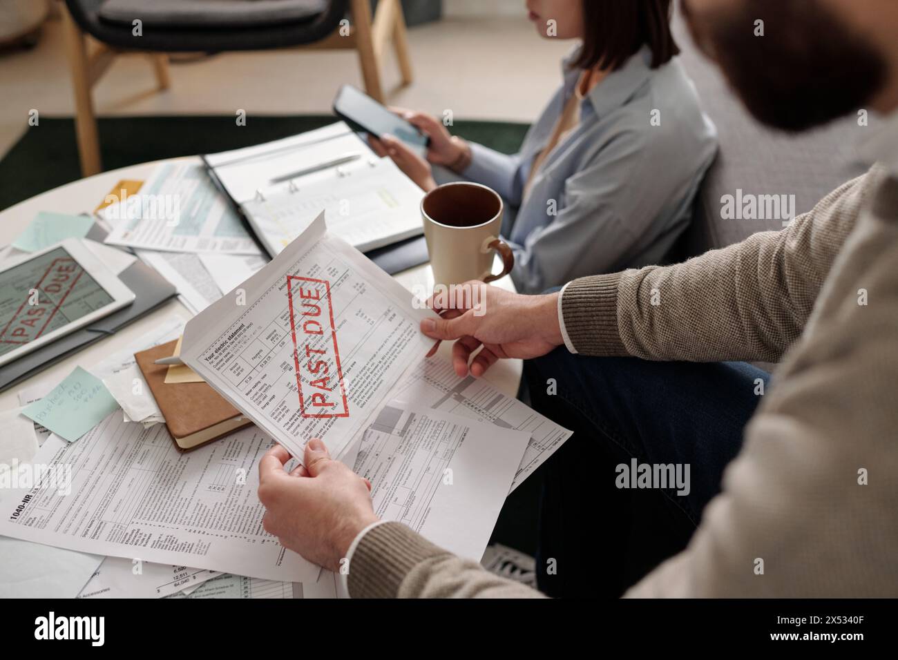 Hands of young unrecognizable man holding final notice bill with past ...