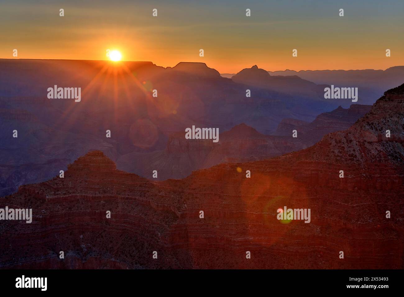 The first rays of the day illuminate the majestic rock faces of the ...