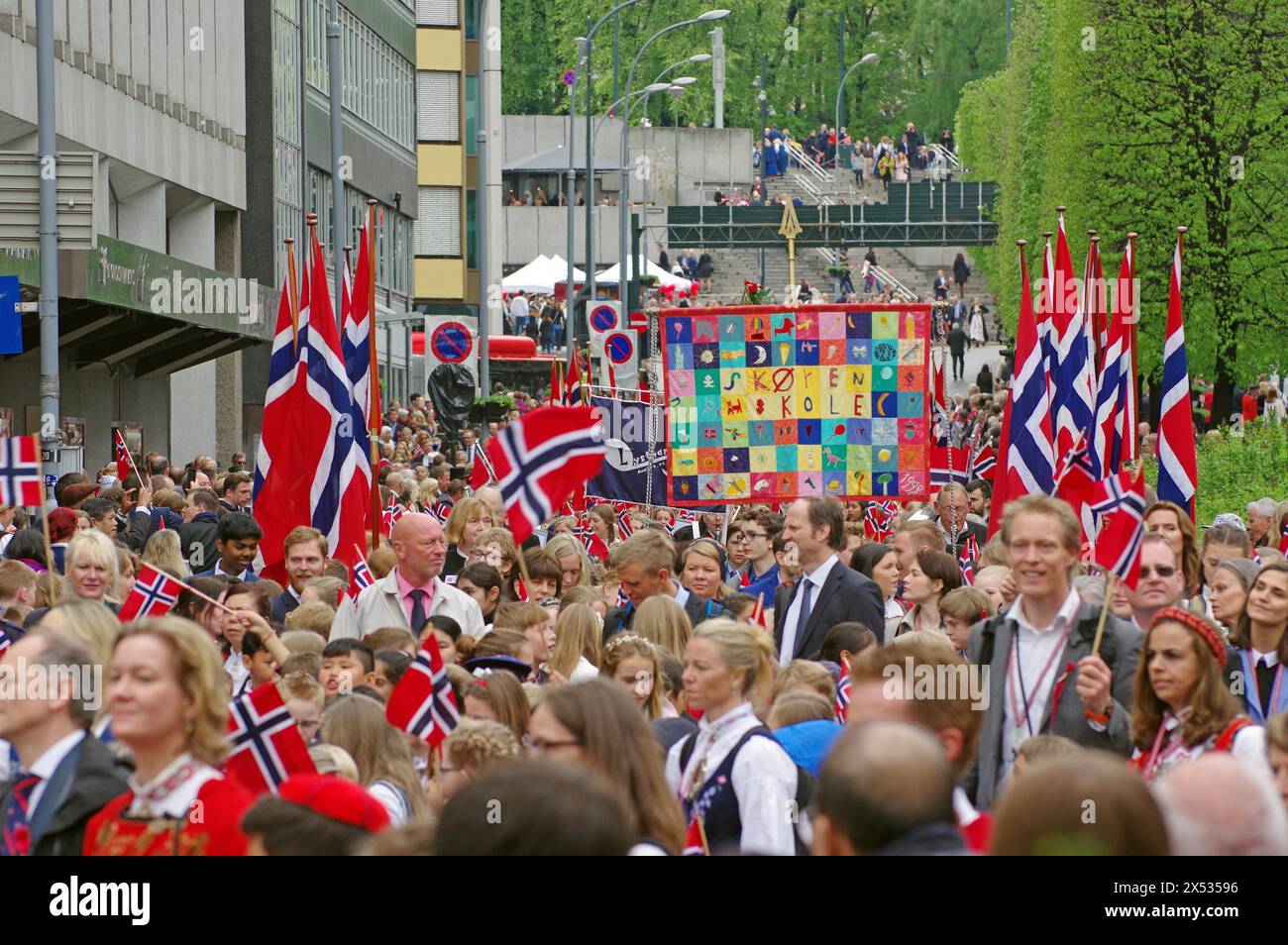 People in traditional costumes waving flags on the streets, folklore ...