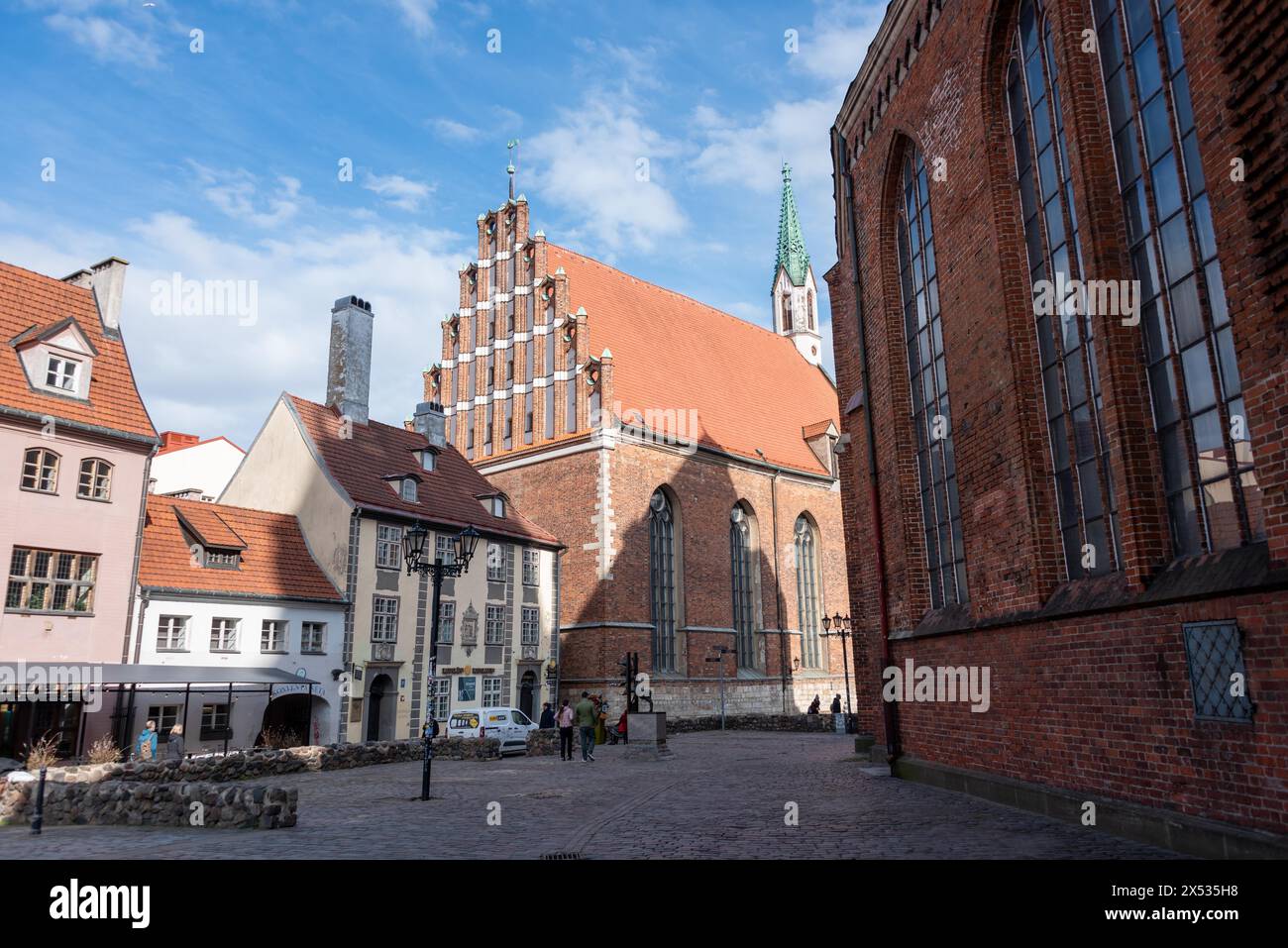 Medieval houses stand in the street of butchers, Skarnu Iela, with St ...