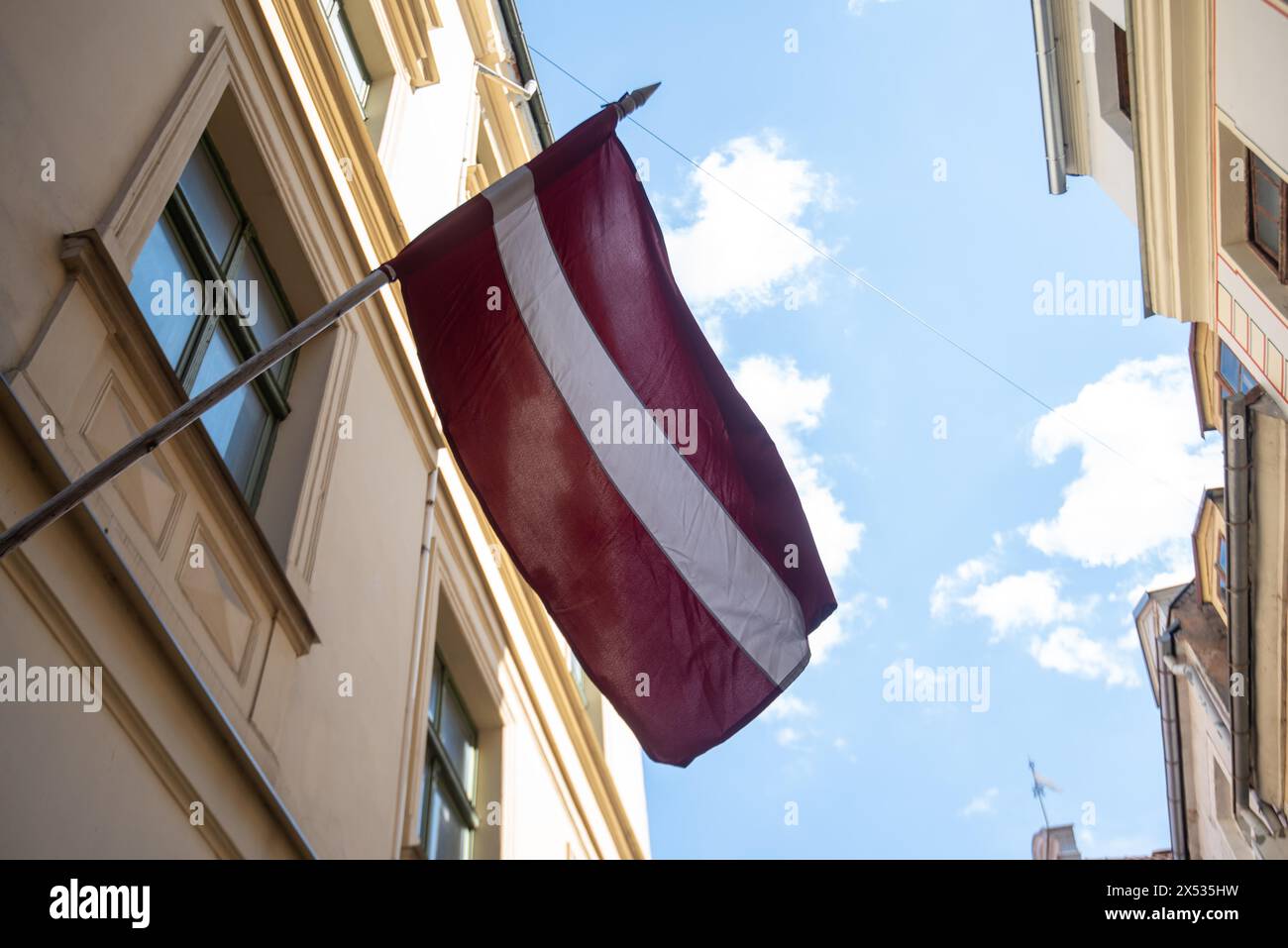 The flag of Latvia flies in the historic centre of Riga, Latvia Stock ...