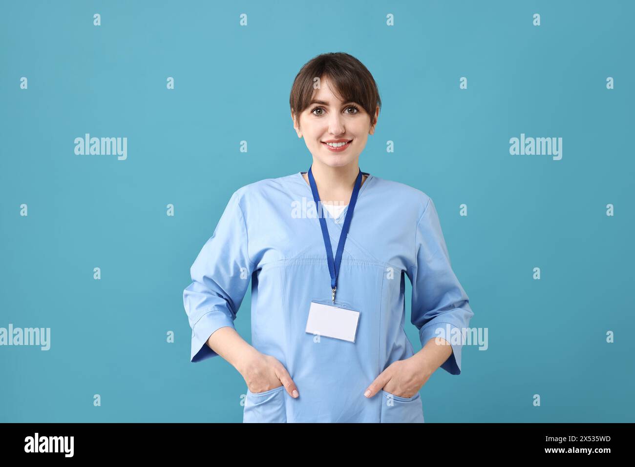 Portrait of smiling medical assistant on light blue background Stock ...
