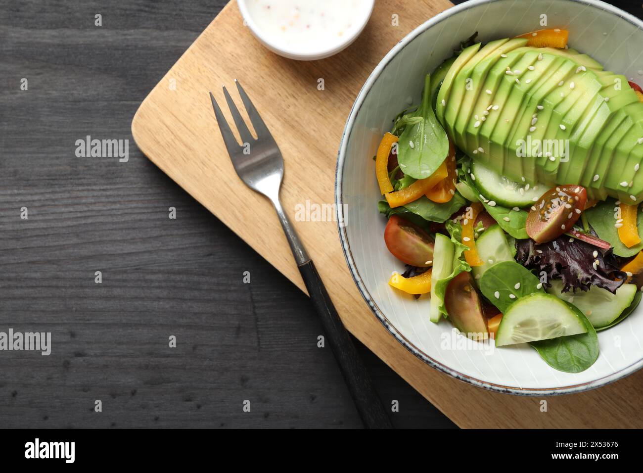 Healthy dish high in vegetable fats on black wooden table, top view ...