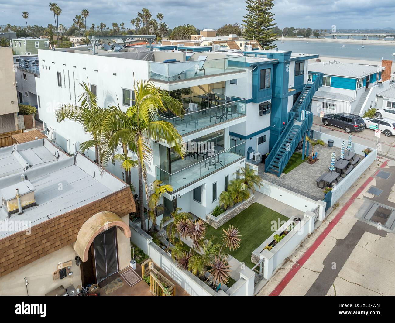 Aerial view of blue and white modern multi story beach homes on Mission ...
