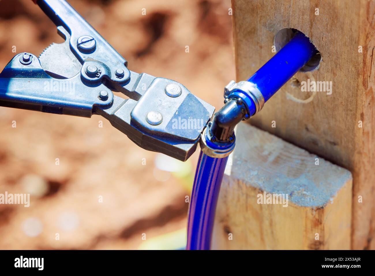 Plumber connects blue PVC pipes for water piping Stock Photo - Alamy
