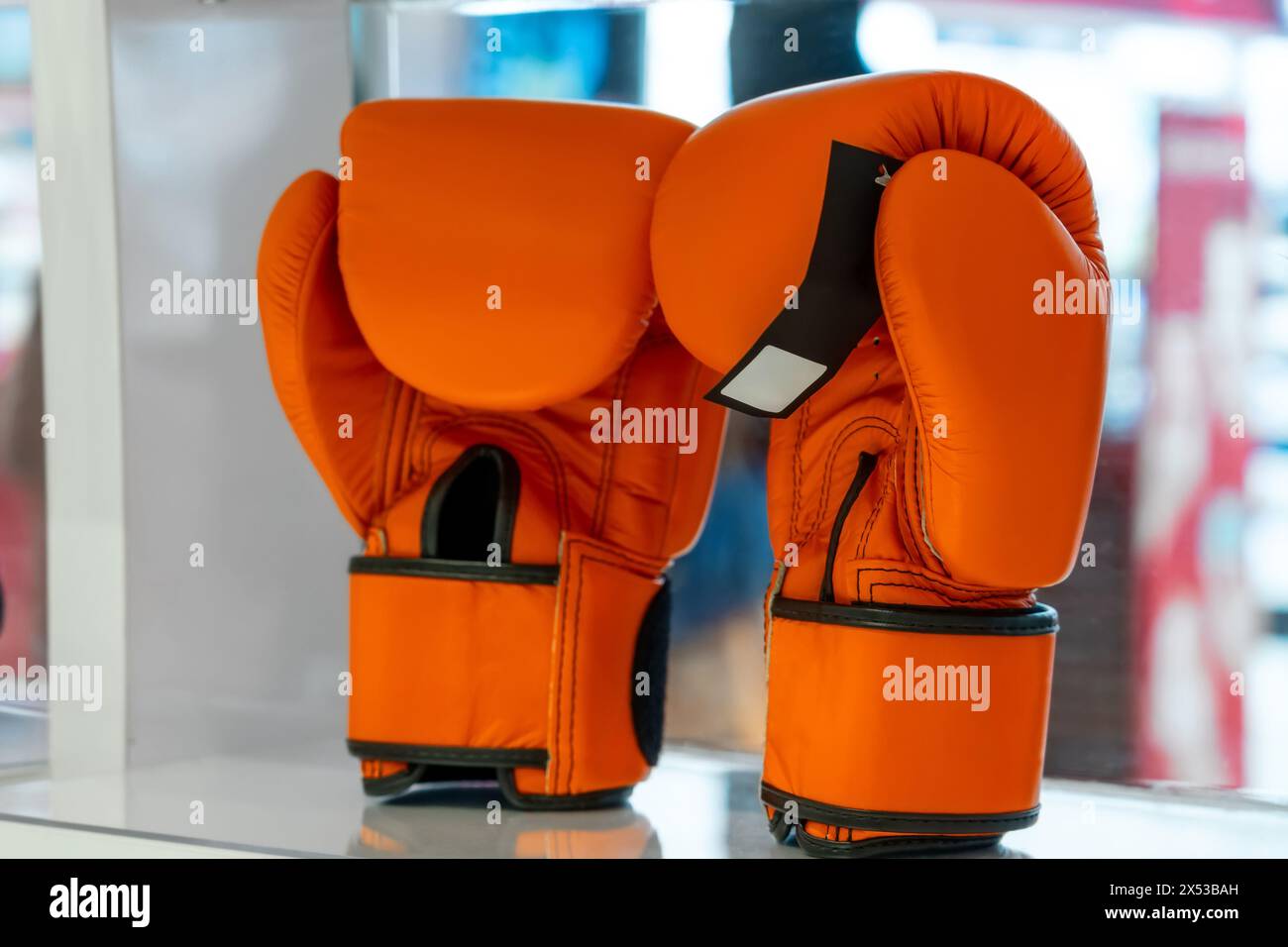 Boxing orange gloves on the shelf of the fightwear shop. Boxing gloves ...