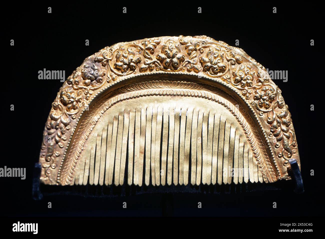 HANGZHOU, CHINA - MAY 7, 2024 - A gold comb with lotus pattern is on ...