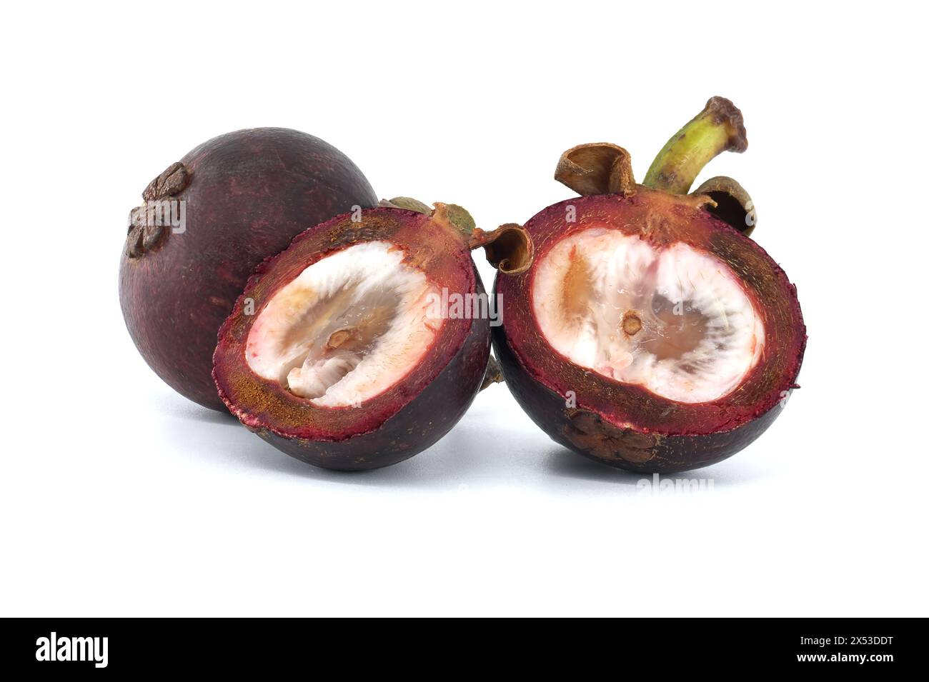 Whole and halved mangosteen fruits display their white inner flesh ...