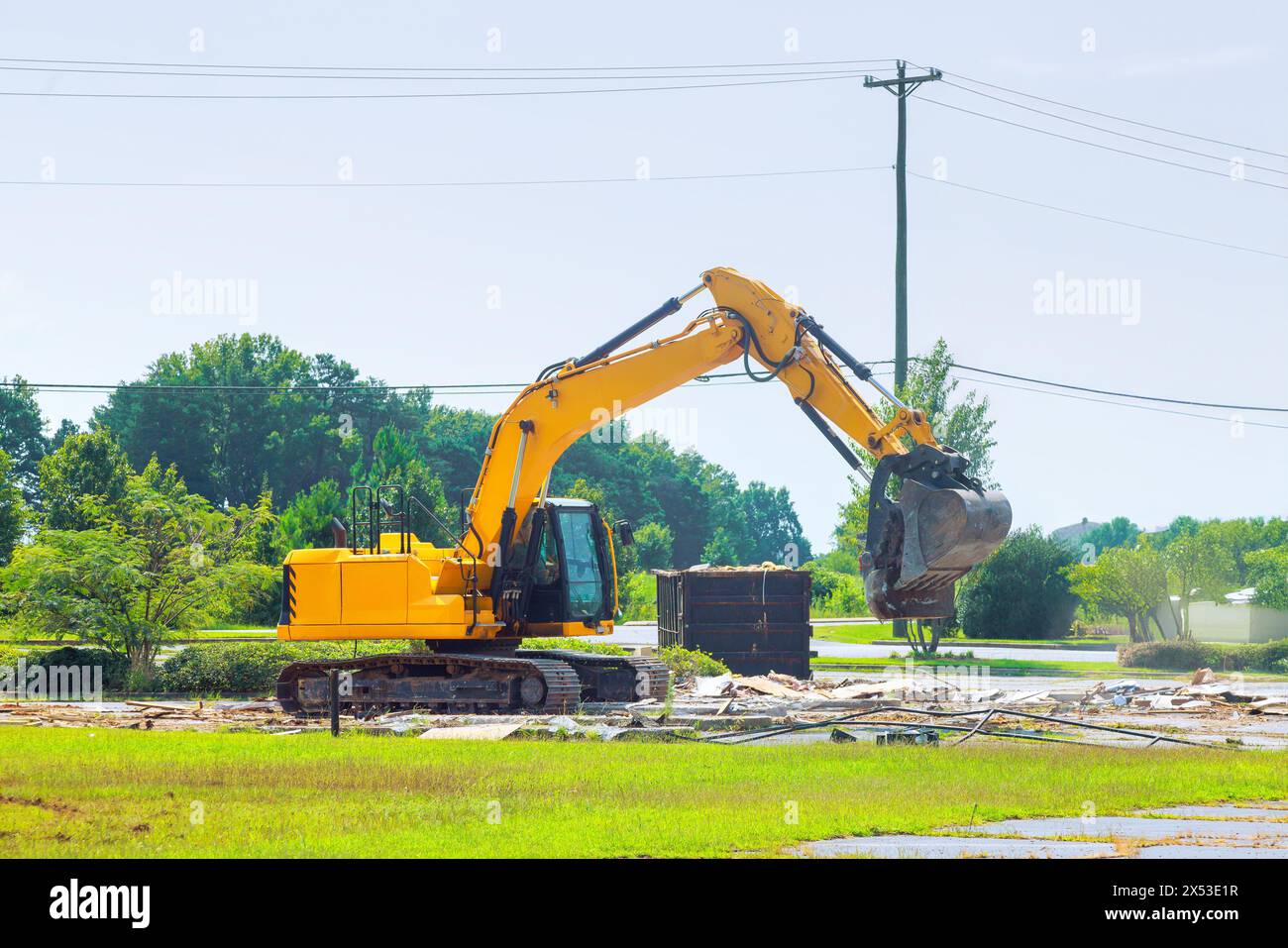 On construction site, an excavator loads construction concrete waste ...