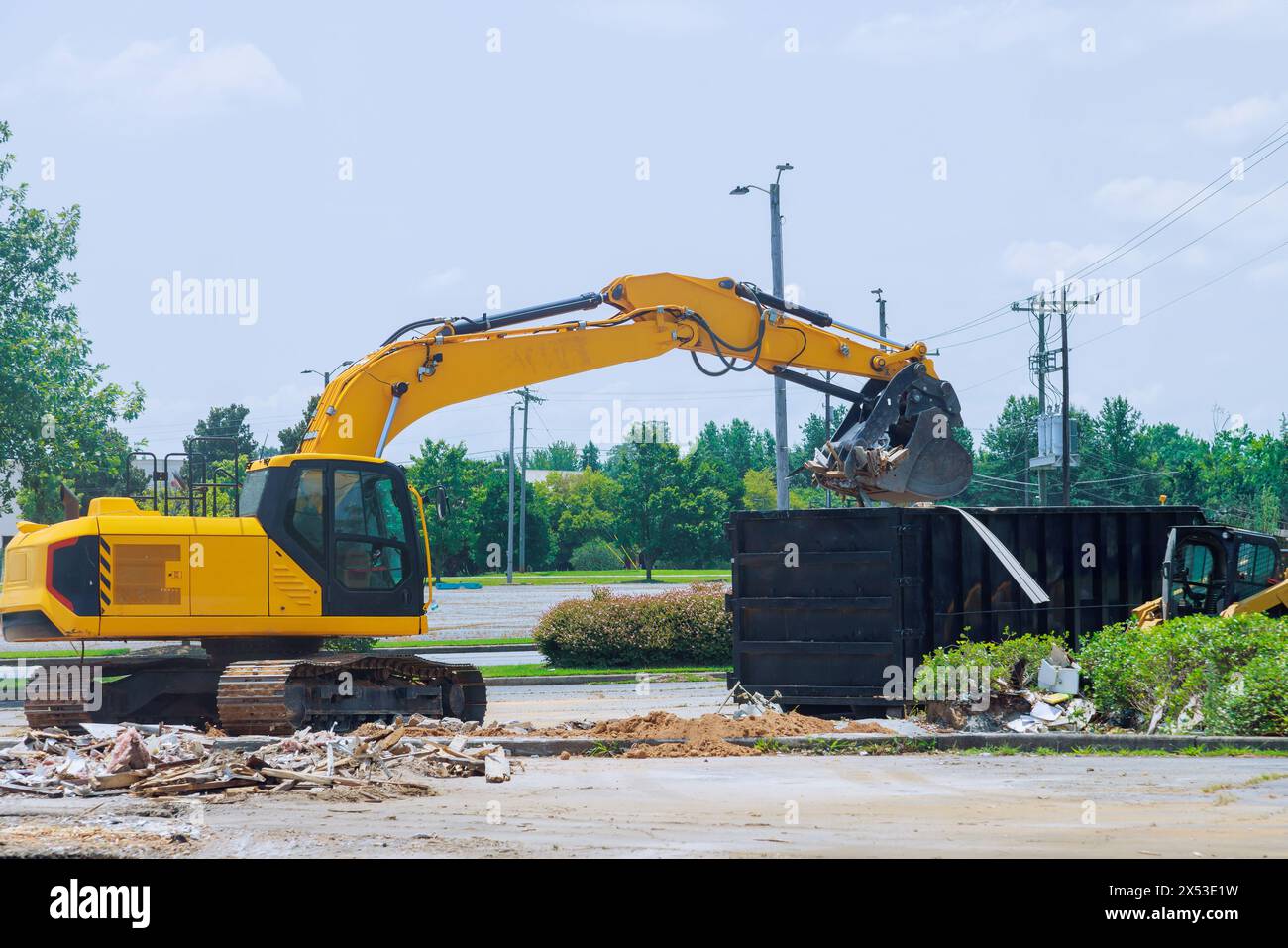 On construction site, an excavator loads construction concrete waste ...