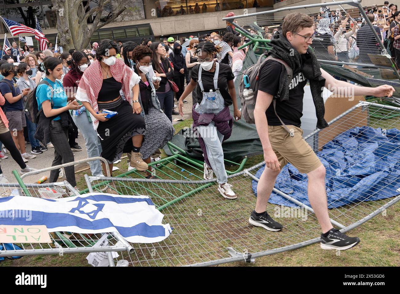 Student protesters walk over the breached fence to take back the MIT ...