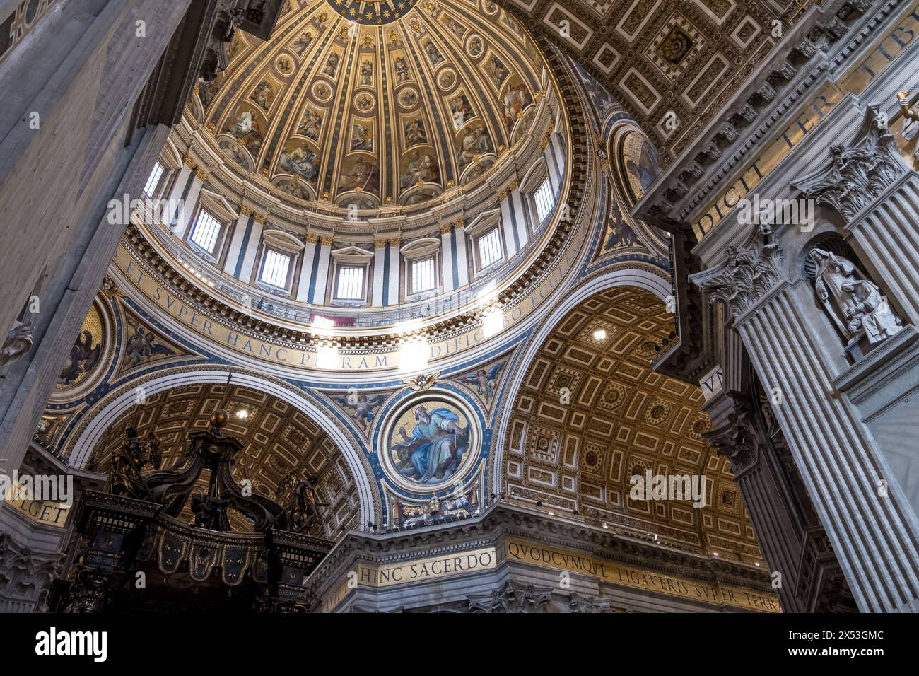 Detail of the dome of Saint Peter’s Basilica, and St. Peter's Baldachin, located in the central ...