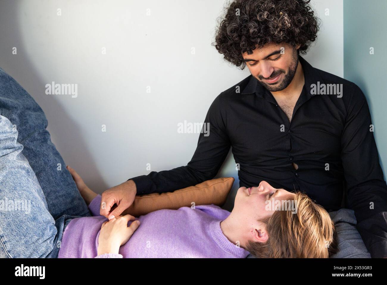 This warm photograph captures an intimate moment between a couple in ...