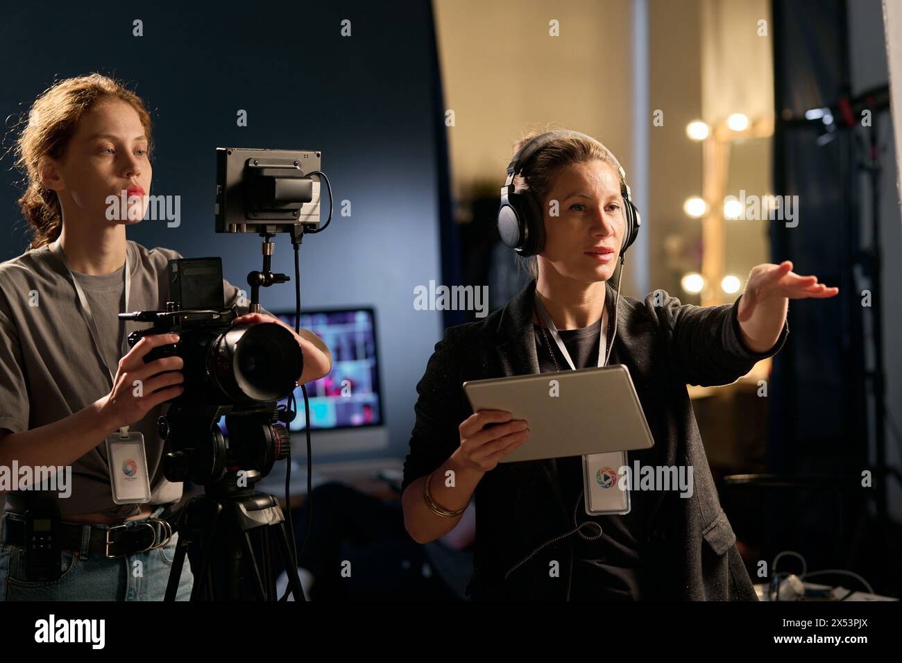 Waist up portrait of female director giving instructions on set during ...