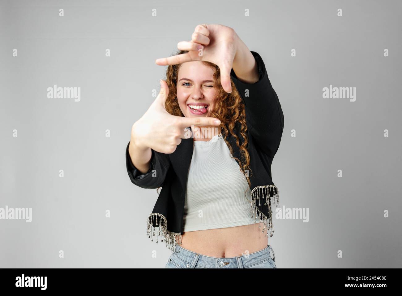 Woman Making Hand Gesture Picture Frame in Studio Stock Photo - Alamy