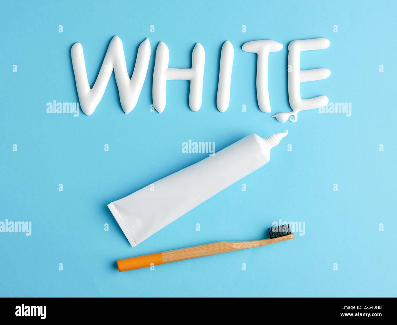 The word white written with toothpaste on blue background. Toothpaste ...