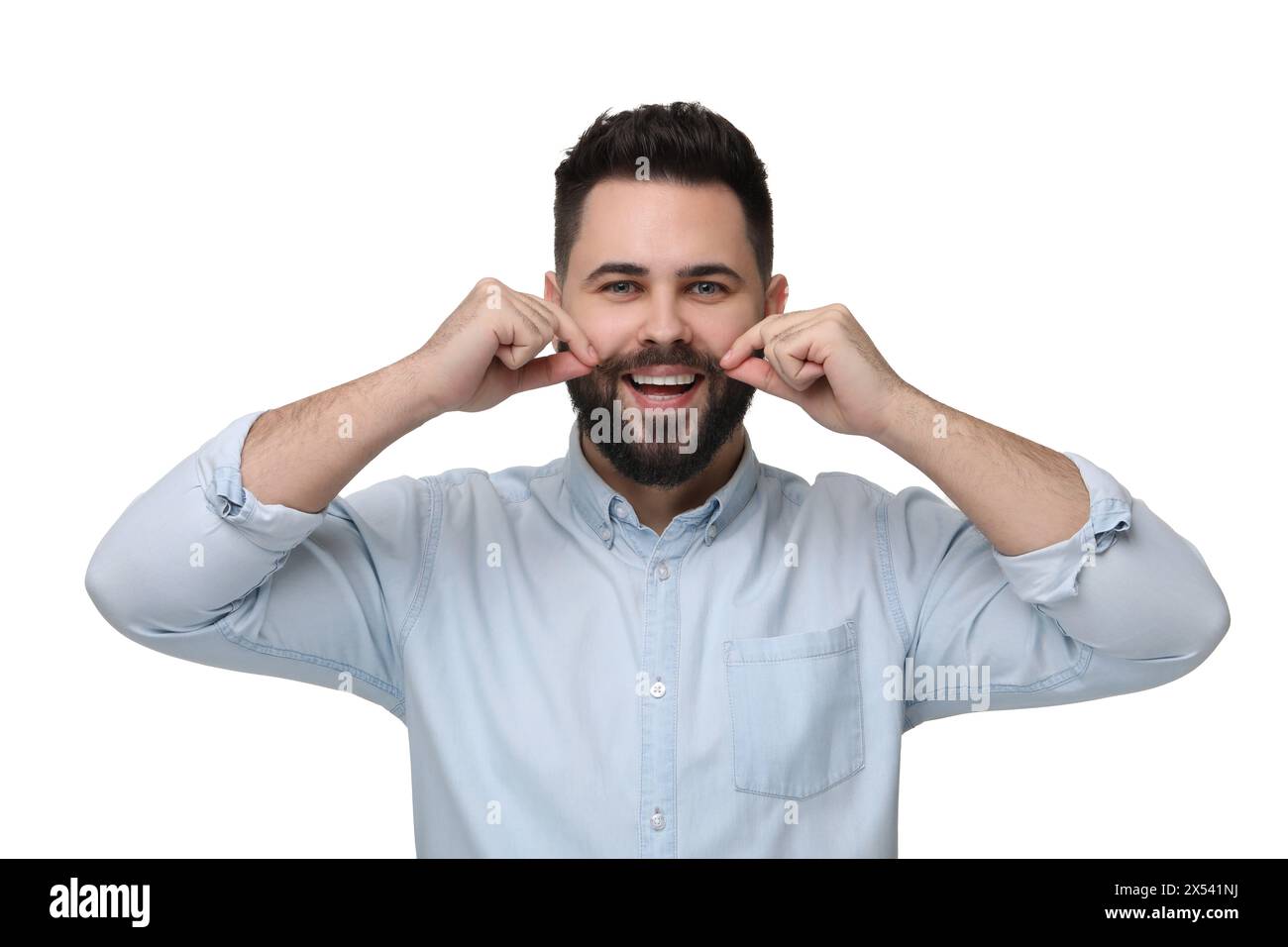 Happy young man touching mustache on white background Stock Photo - Alamy