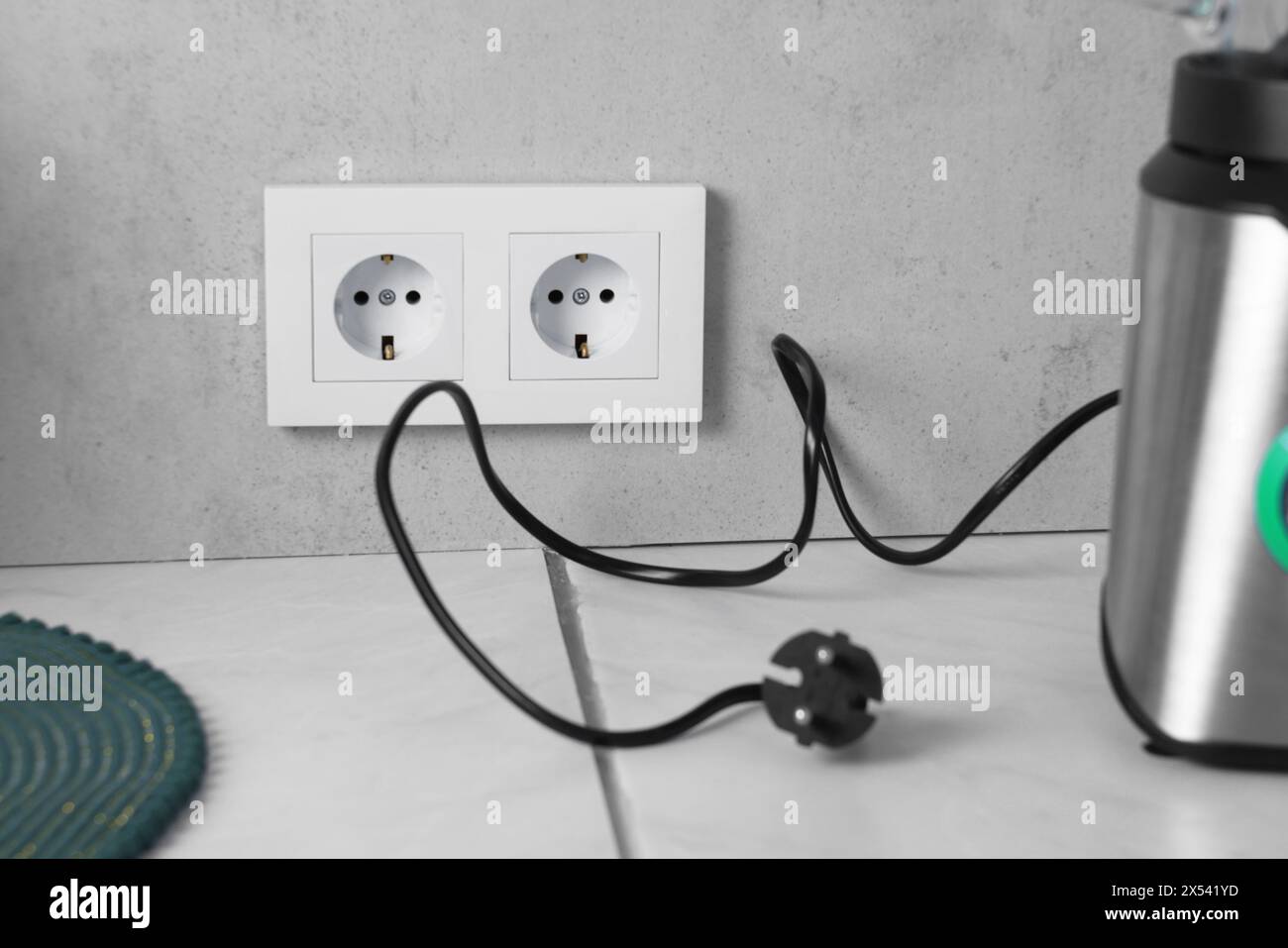 Power sockets and blender on white table Stock Photo - Alamy